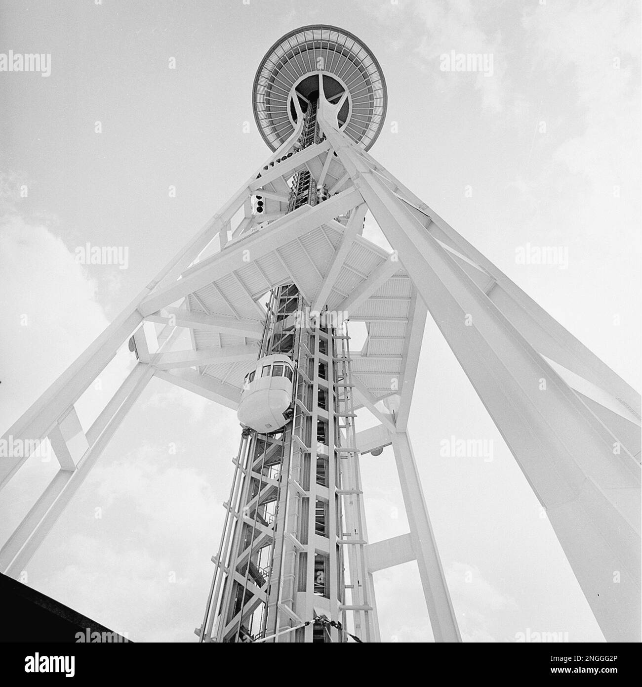 This is a skyward view of the Space Needle with one of its two ...