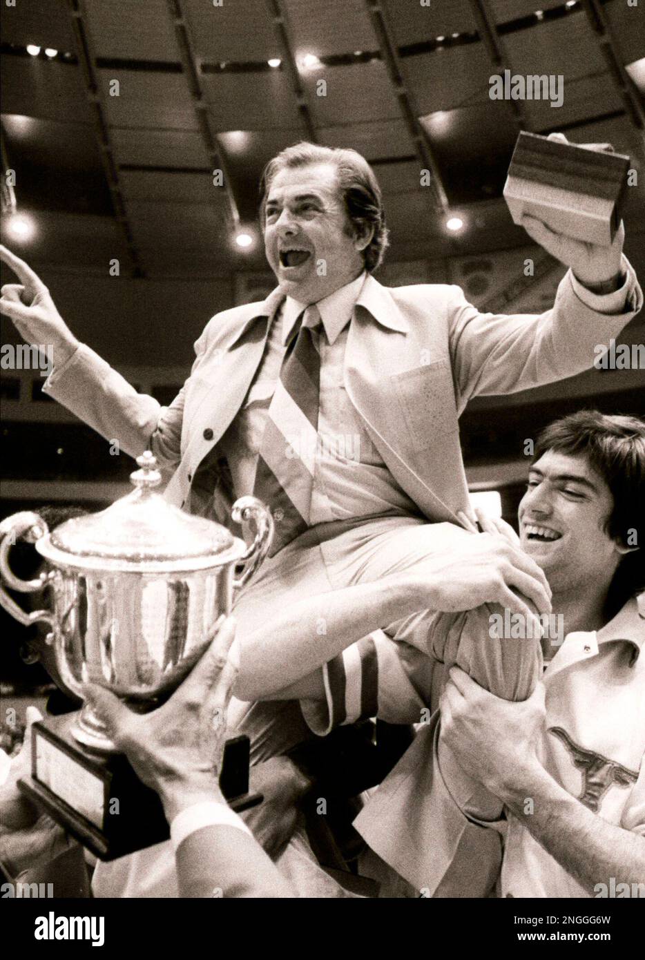 Texas Longhorn basketball players hoist coach Abe Lemons on their ...