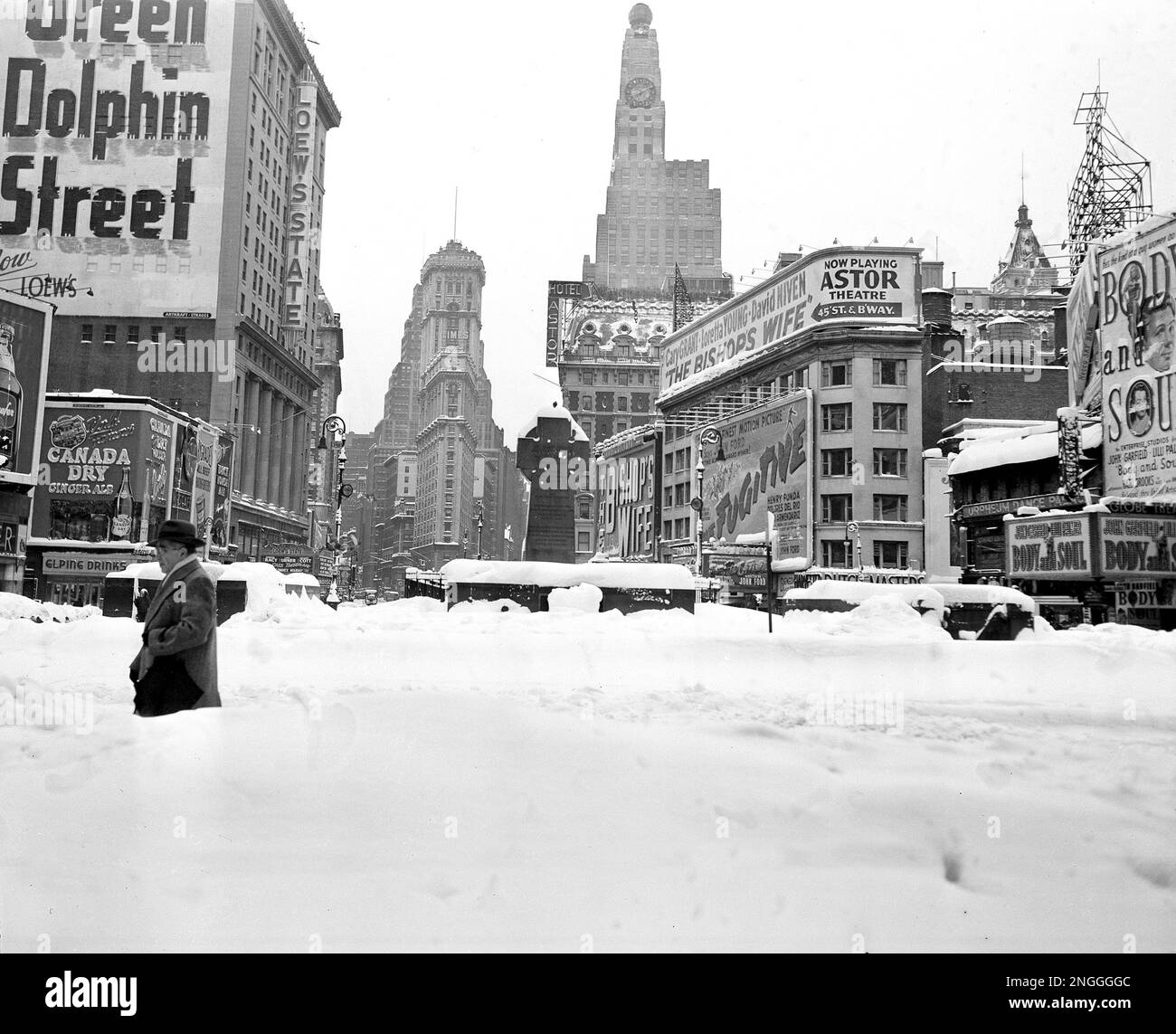 A pedestrian walks between drifts of snow in Times Square in New York ...