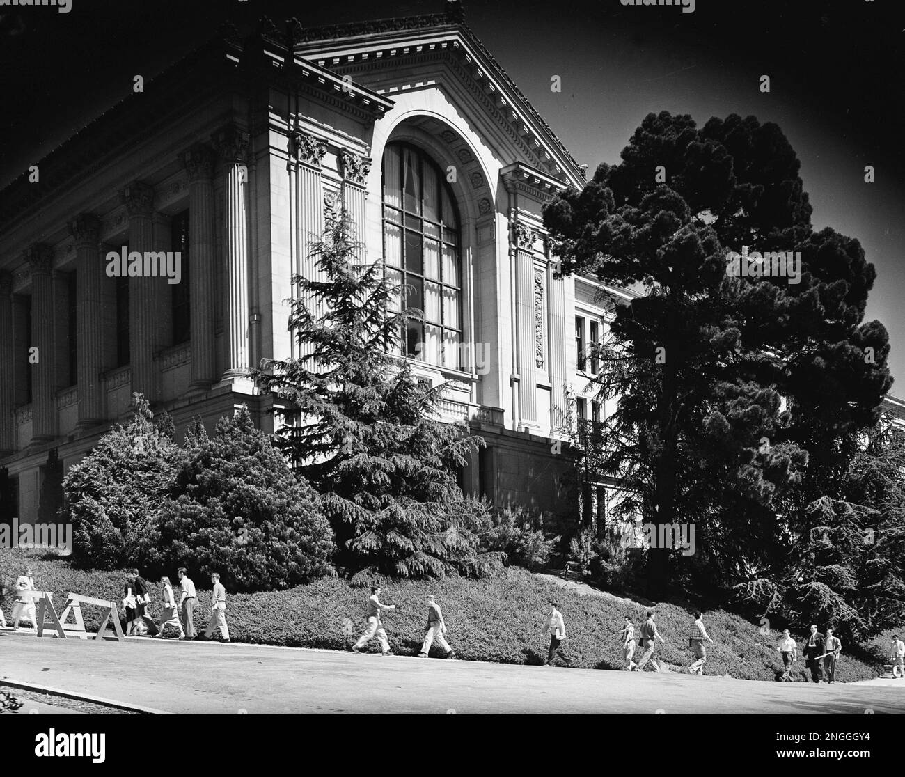 Students walk past the building of Doe Memorial Library, housing more ...