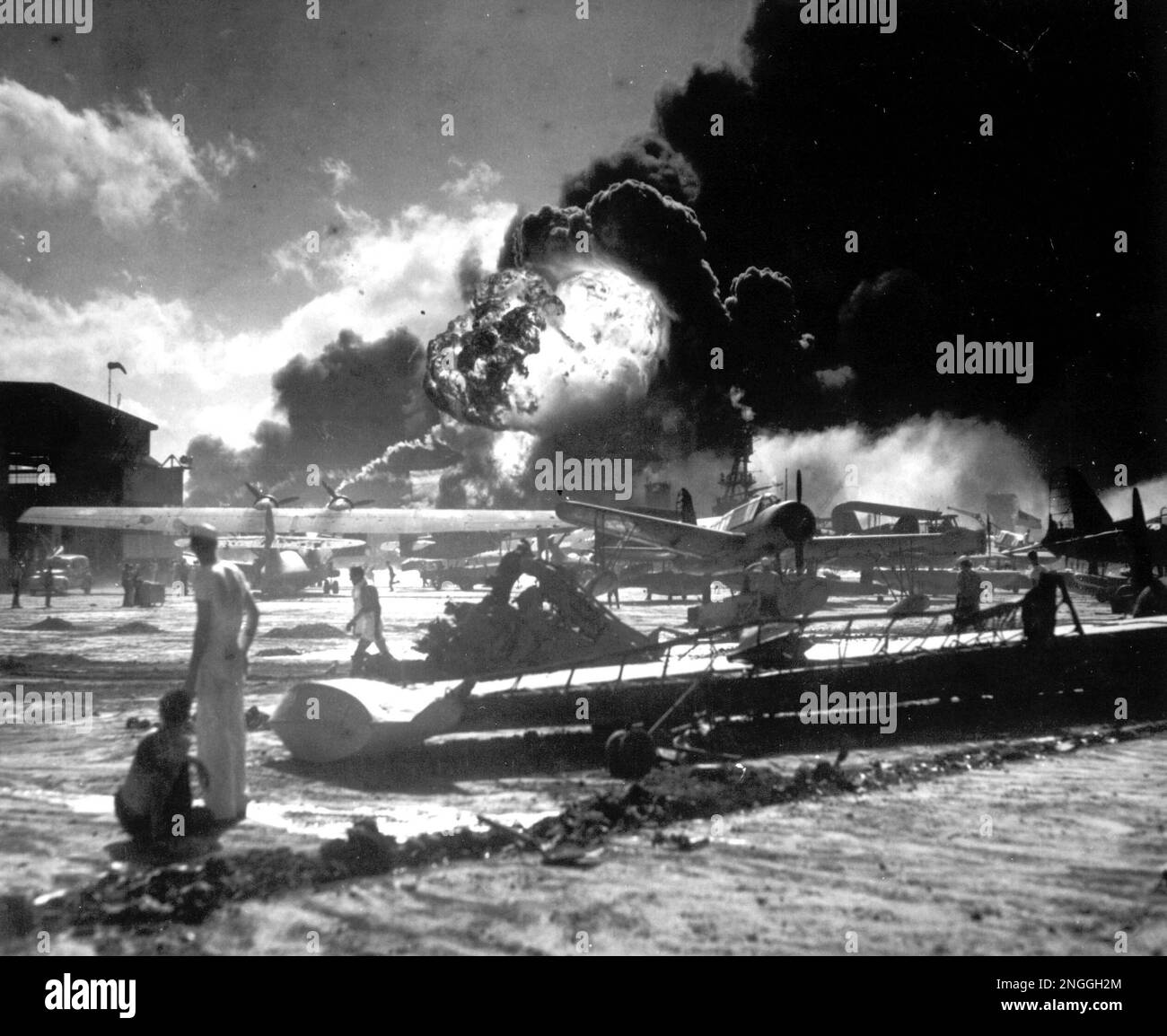 Sailors stand among wrecked airplanes at Ford Island Naval Air Station ...