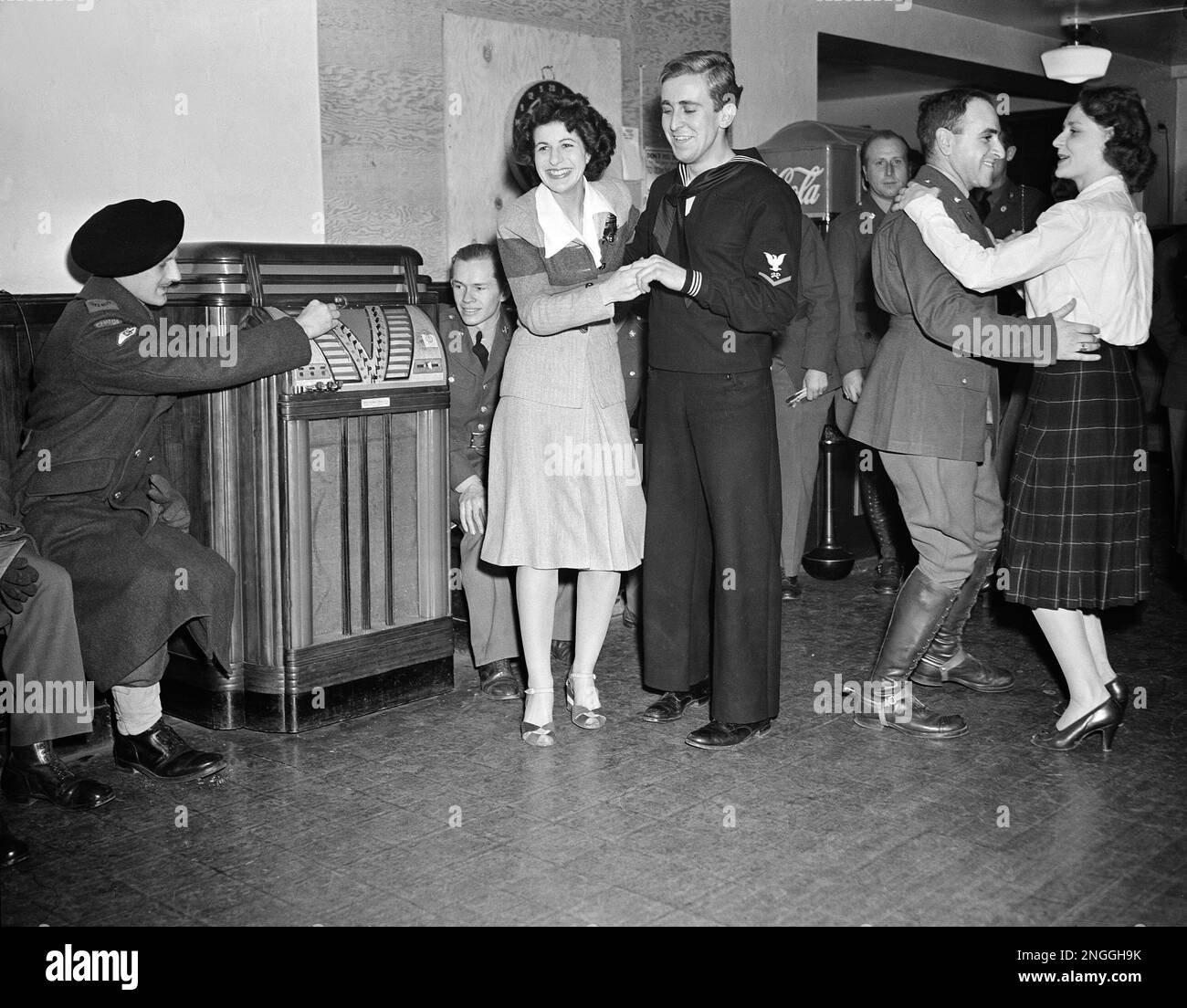 USO dance instructors dance to the jukebox with U.S. army servicemen at ...