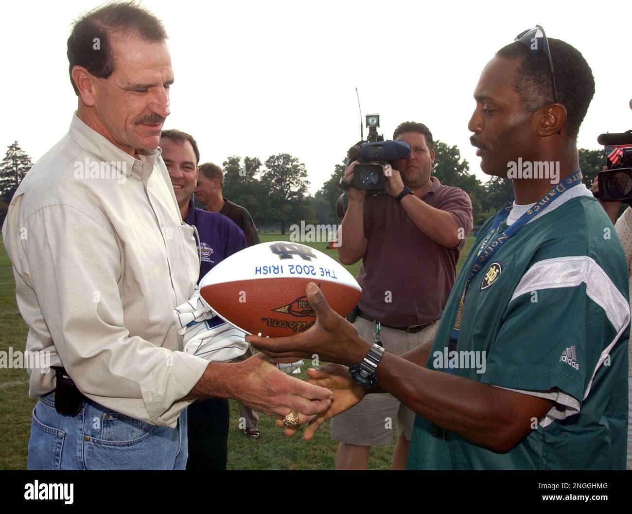 Notre Dame football coach Tyrone Willingham, right, hands an ...