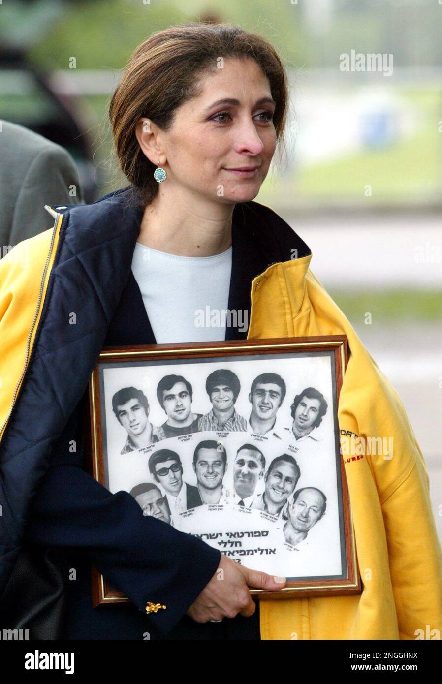 Osrat Iosef, from Israel, holds a picture of the eleven Israelis who ...