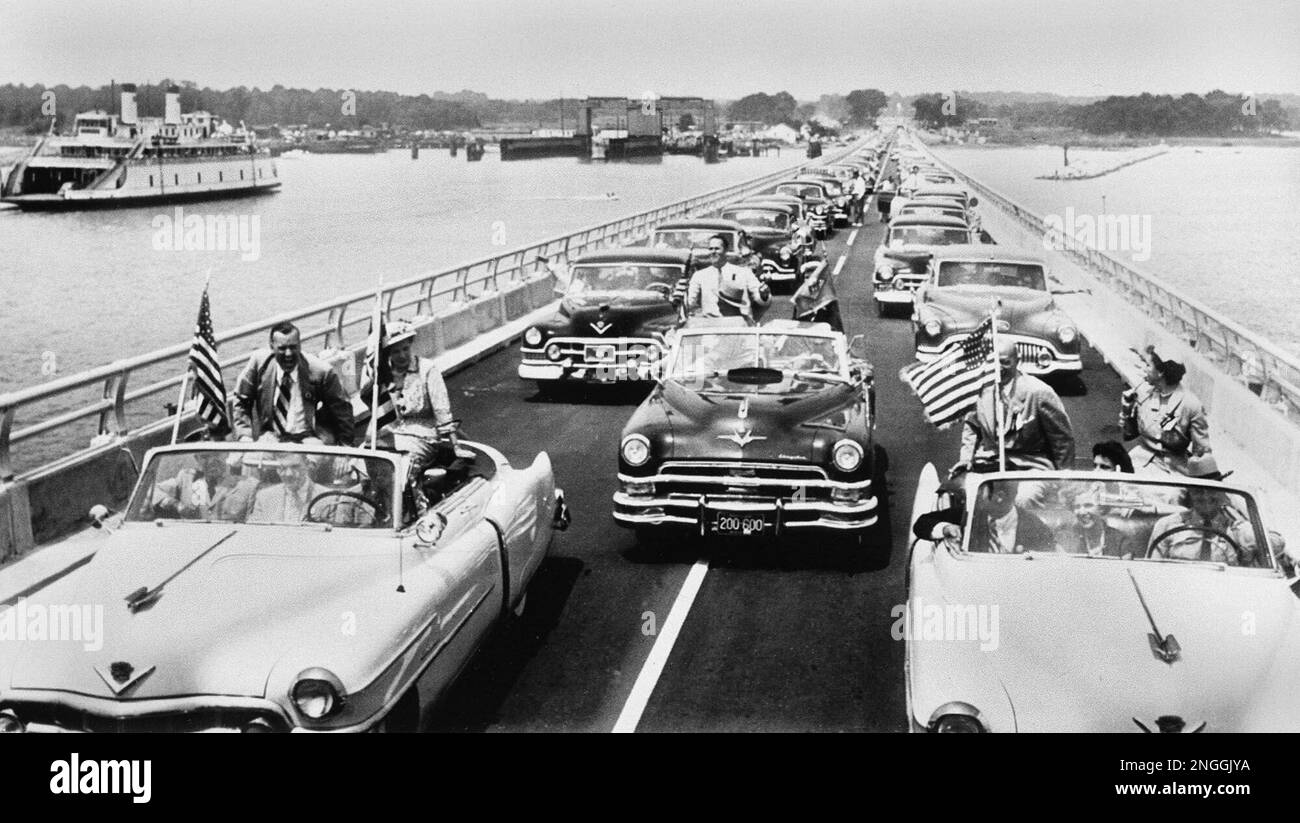 As a ferry leaves its slip, a motorcade crosses the new Chesapeake Bay ...