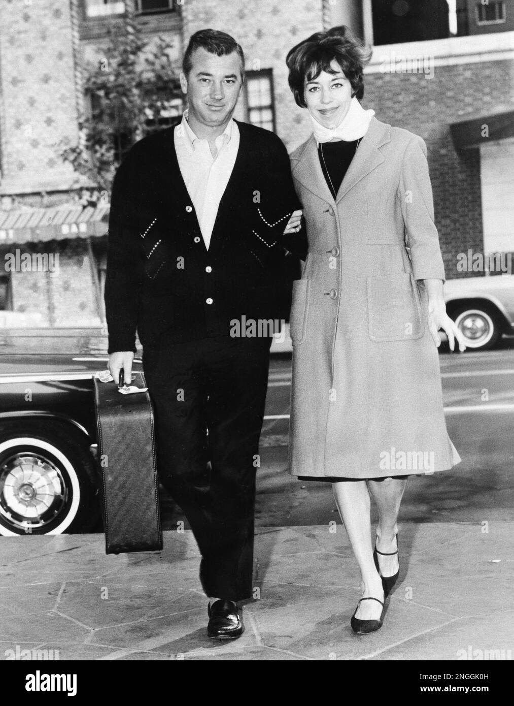 Comedienne Carol Burnett, wearing a neck brace, is accompanied by her ...