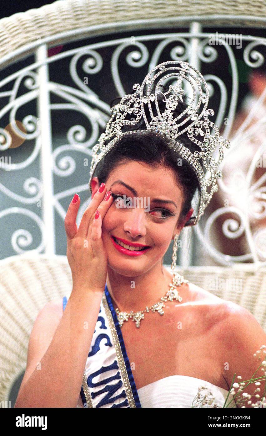 Dayanara Torres, Miss Puerto Rico, is seen wiping a tear from her eye ...