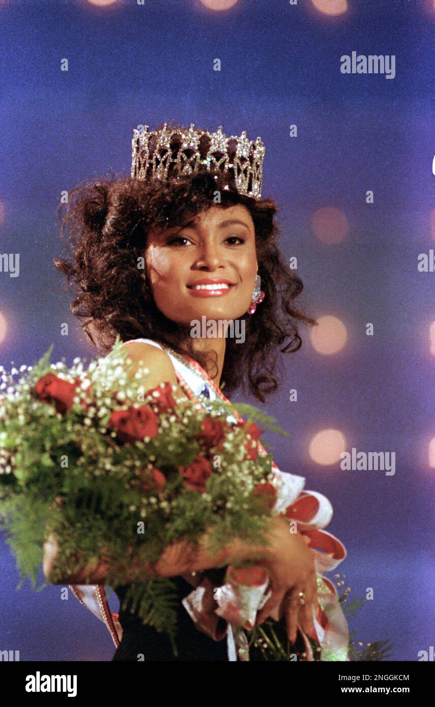 Miss Michigan Carole Gist, of Detroit, carries roses as she parades on ...