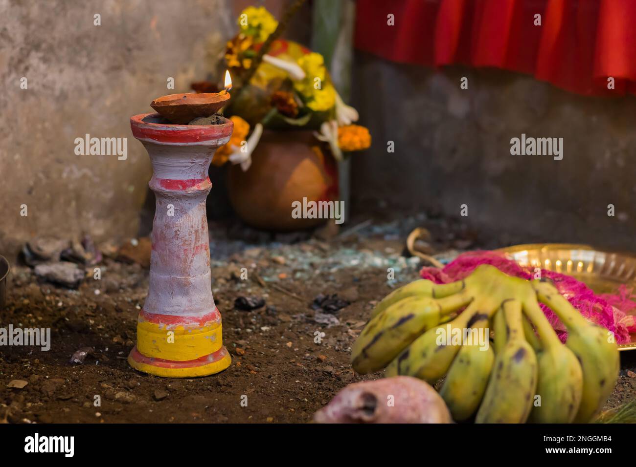 Clay lamp on pilsuj stand burning with yellow flame illuminated for ...