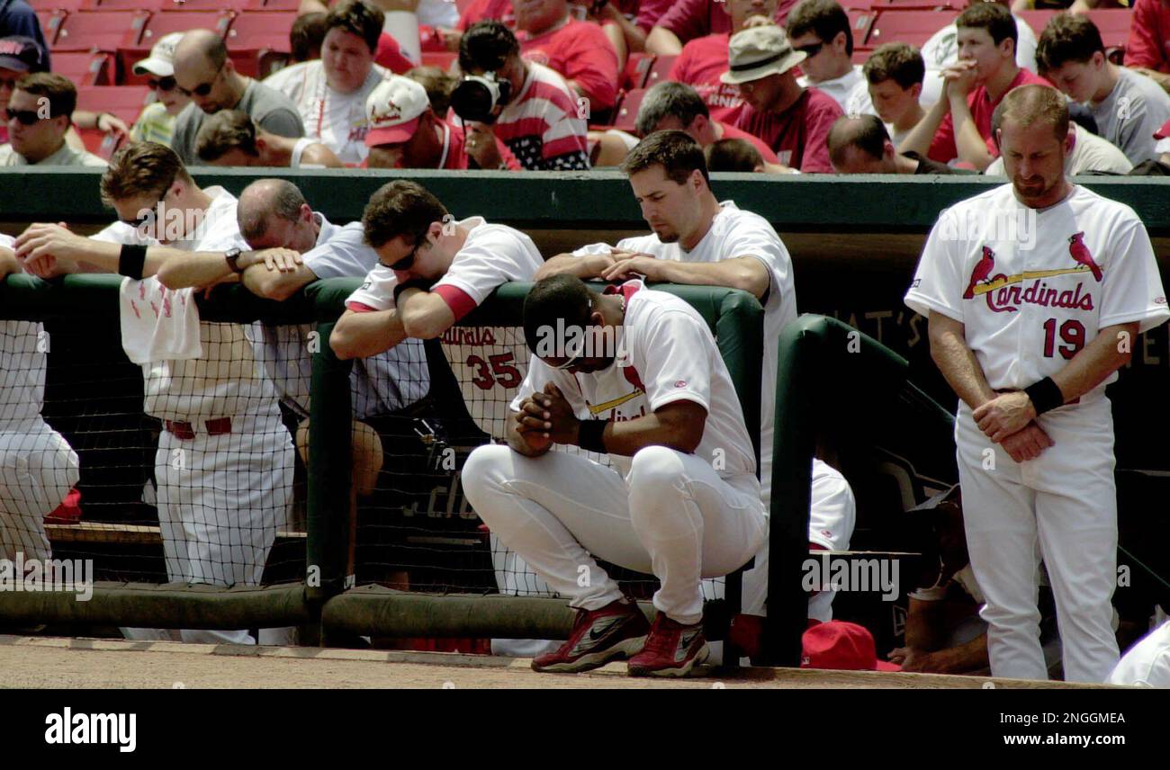 Members of the St Louis Cardinals baseball team bow thier heads in ...