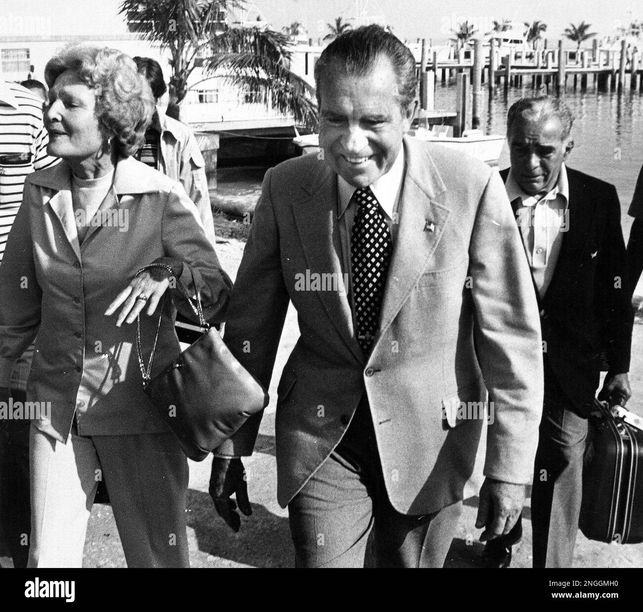 Former President Richard Nixon, accompanied by his wife Pat and banker ...