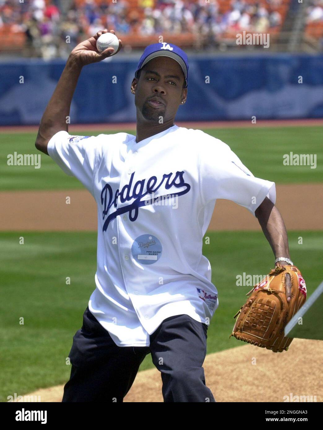 Comedian and actor Chris Rock, right, throws the ceremonial first pitch ...