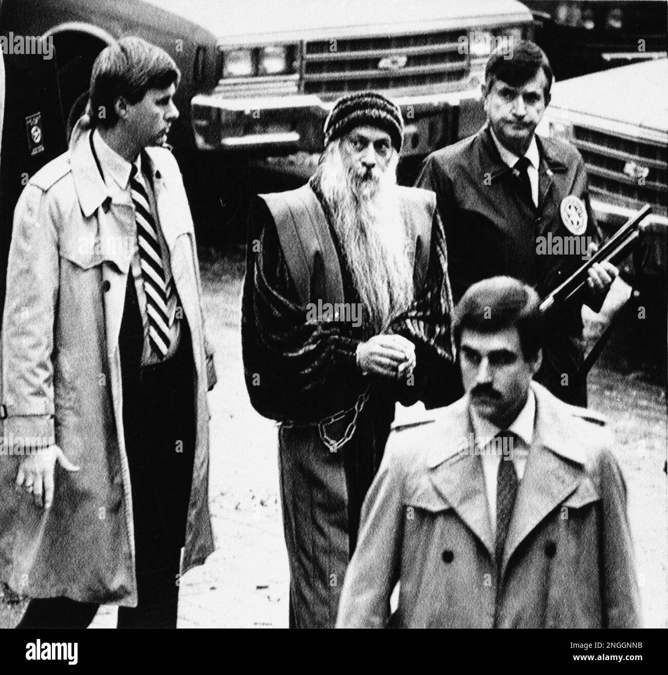 Federal officers lead away Bhagwan Shree Rajneesh, the Indian guru, who ...