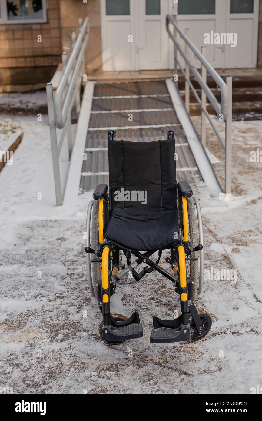 Empty wheelchair in the hospital on the ramp. Wheelchair close-up ...