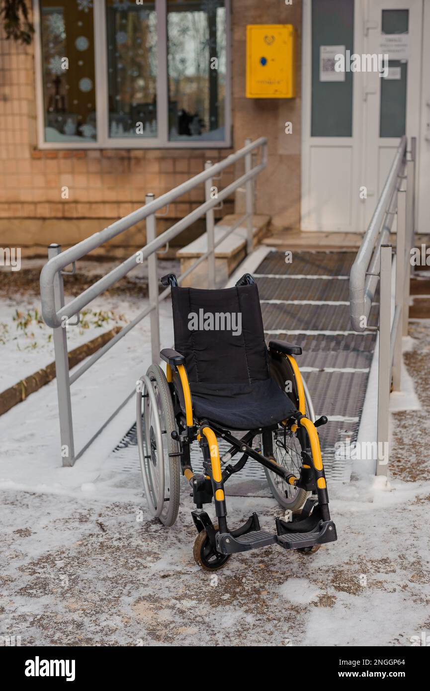 Empty wheelchair in the hospital on the ramp. Wheelchair close-up ...