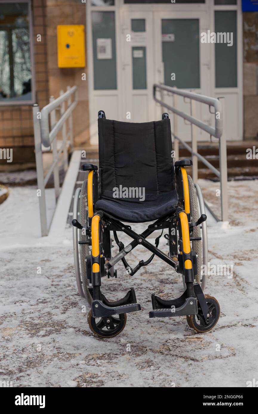 Empty wheelchair in the hospital on the ramp. Wheelchair close-up ...