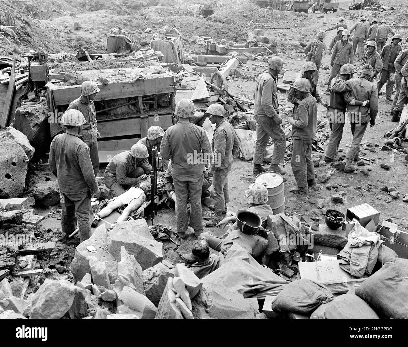 A wounded U.S. Marine soldier, lying on stretcher at left, is given ...