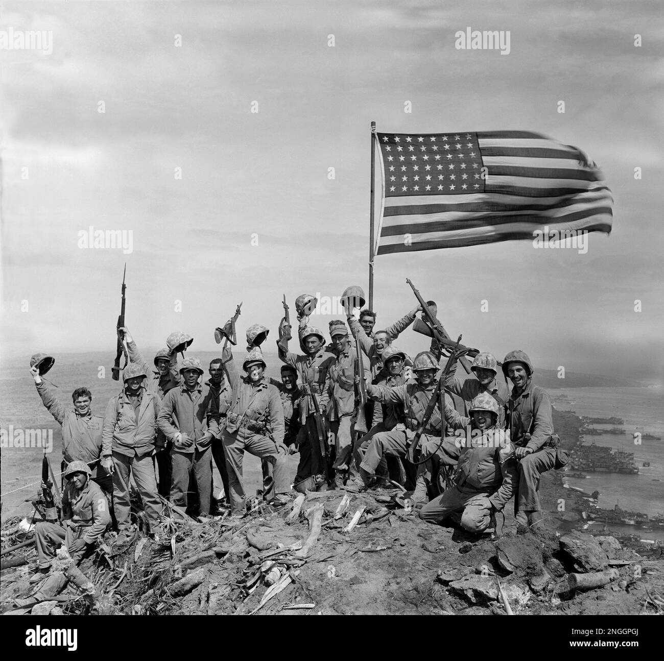 U.S. Marines of the 28th Regiment, fifth division, cheer and hold up ...