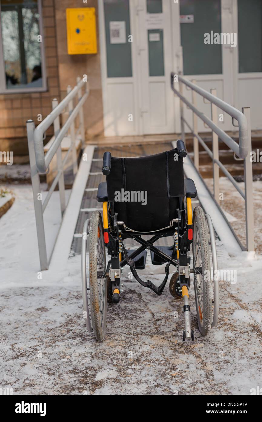 Empty wheelchair in the hospital on the ramp. Wheelchair close-up ...