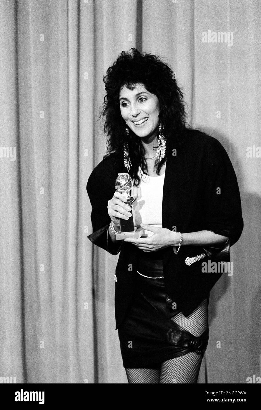 Actress and singer Cher smiles with her award at the annual Golden ...