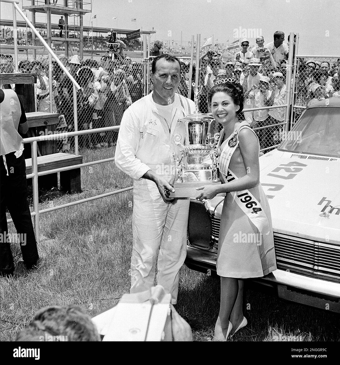 A.J. Foyt, of Houston, Texas, holds the trophy with Miss Dixie Carol ...