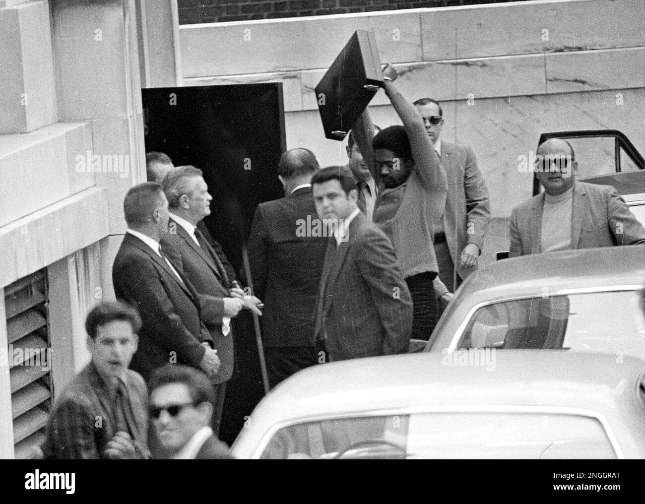 Black Panther Chairman Bobby G. Seale, holding attache case aloft as he ...