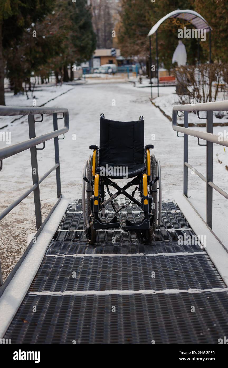 Empty wheelchair in the hospital on the ramp. Wheelchair close-up ...