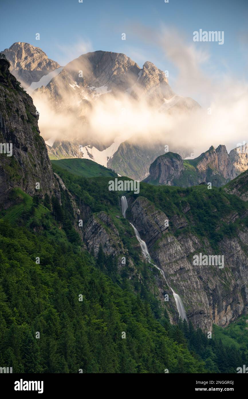 A waterfall flowing down a steep mountain Stock Photo - Alamy