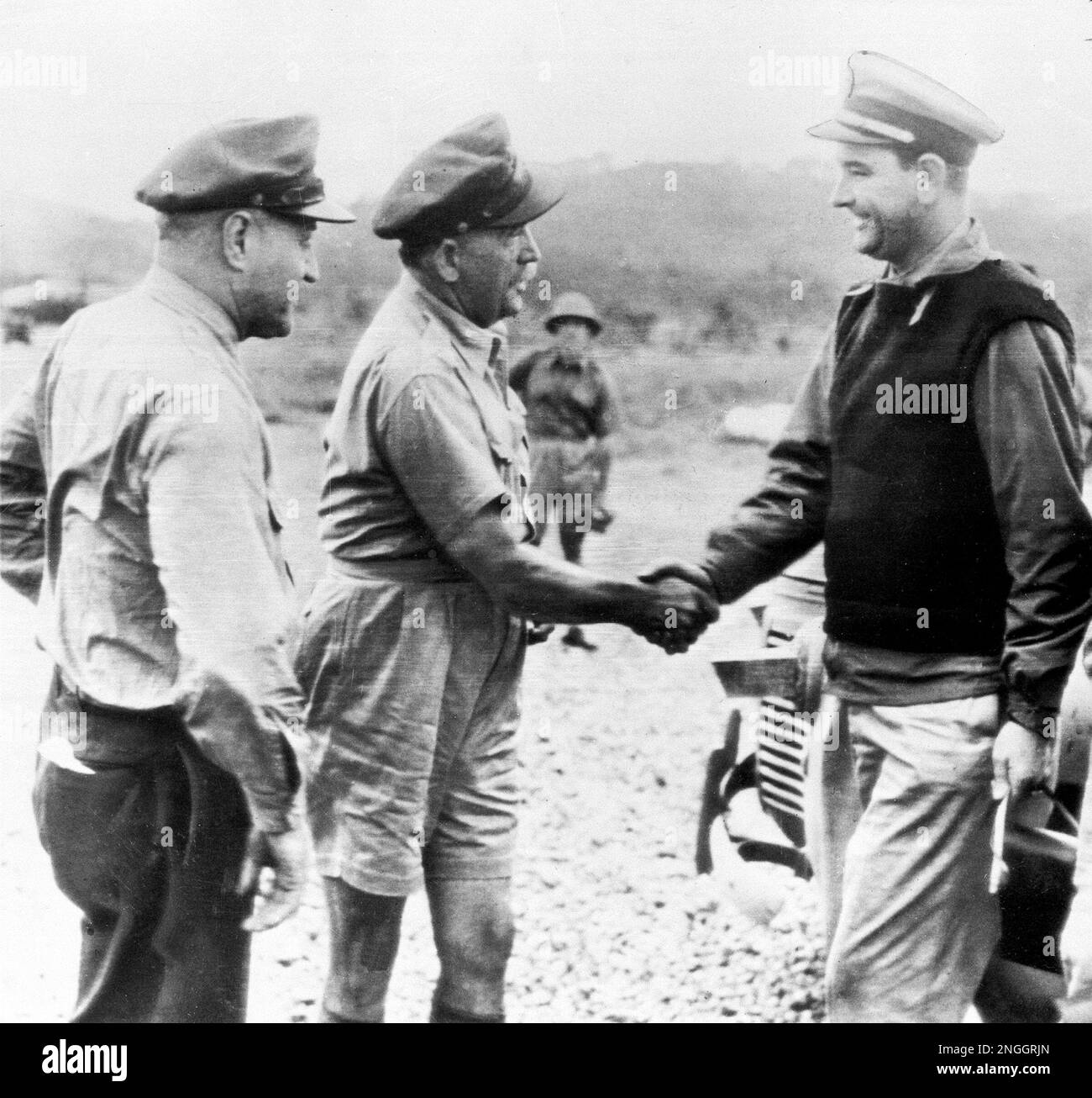 Navy Lt. Cmdr. Lyndon B. Johnson, right, Texas congressman, is greeted ...