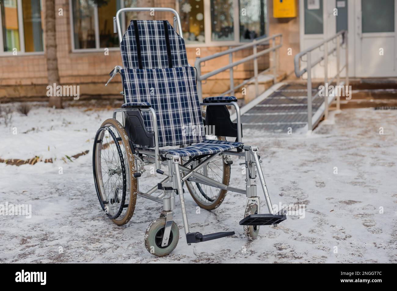 Empty wheelchair in the hospital on the ramp. Wheelchair close-up ...