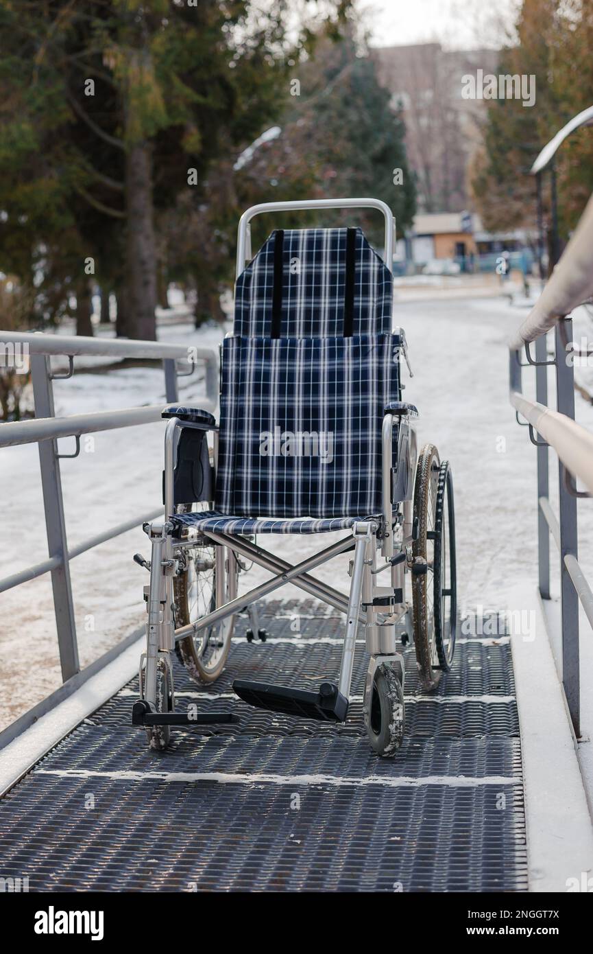 Empty wheelchair in the hospital on the ramp. Wheelchair close-up ...