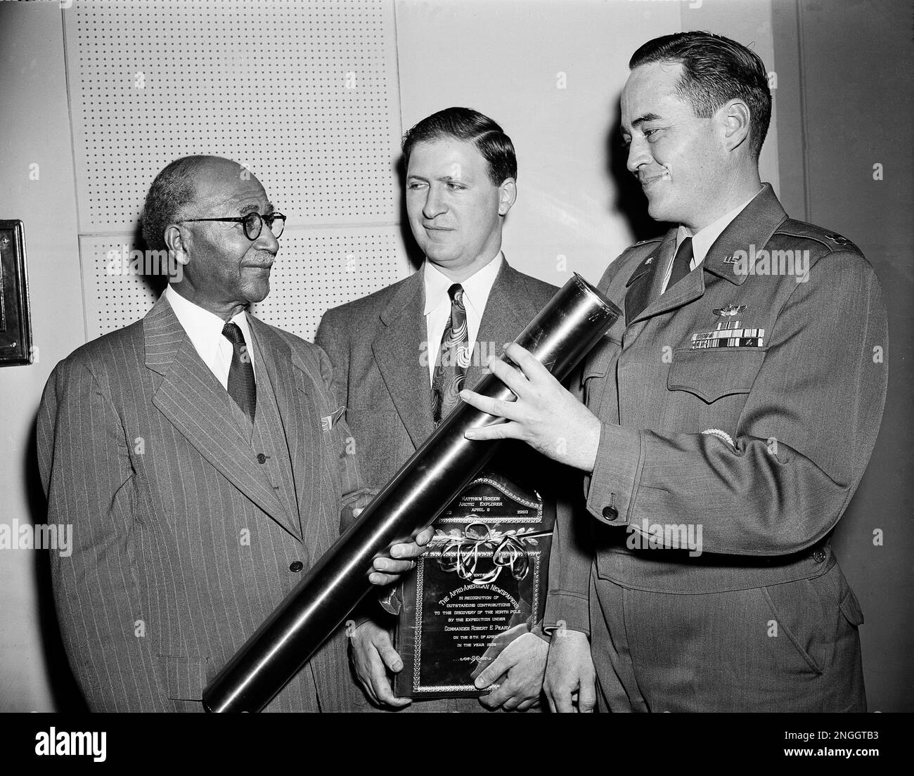 Matthew A. Henson, left, 83, receives a plaque from the Afro-American ...