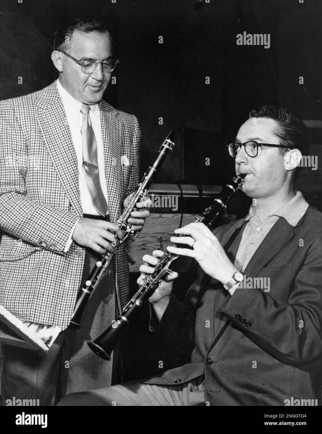 Jazz musician Benny Goodman, standing, gives comedian and television ...