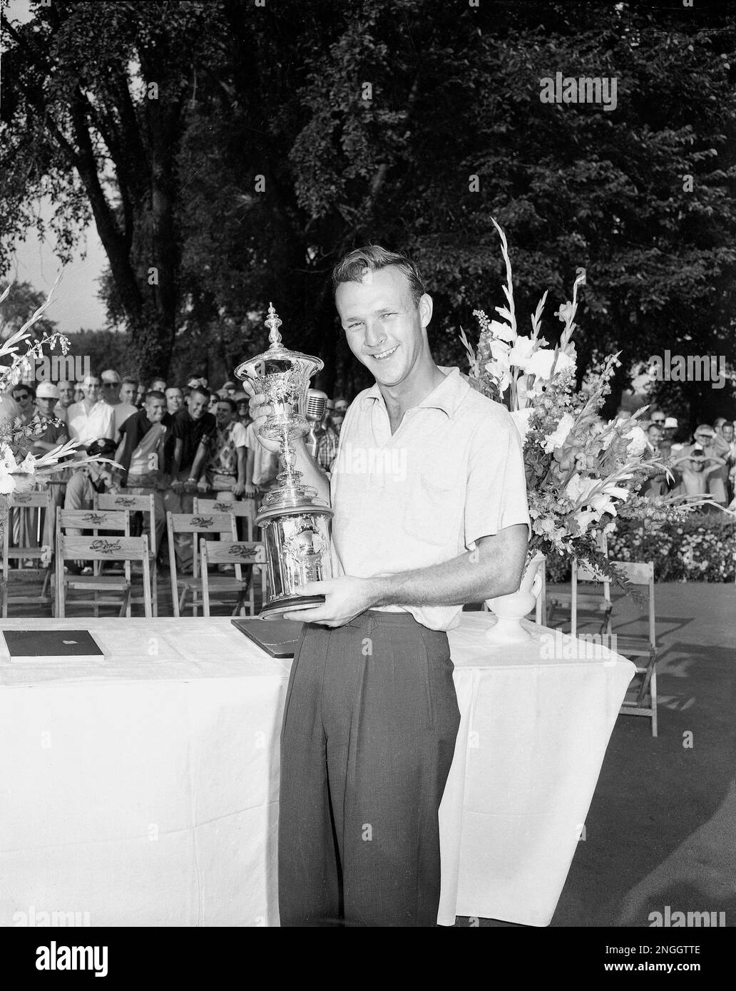 Arnold Palmer holds his trophy after winning the National Amateur Golf ...