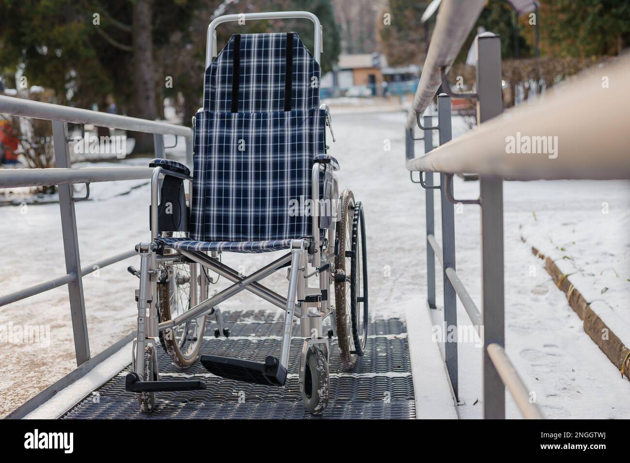 Empty wheelchair in the hospital on the ramp. Wheelchair close-up ...