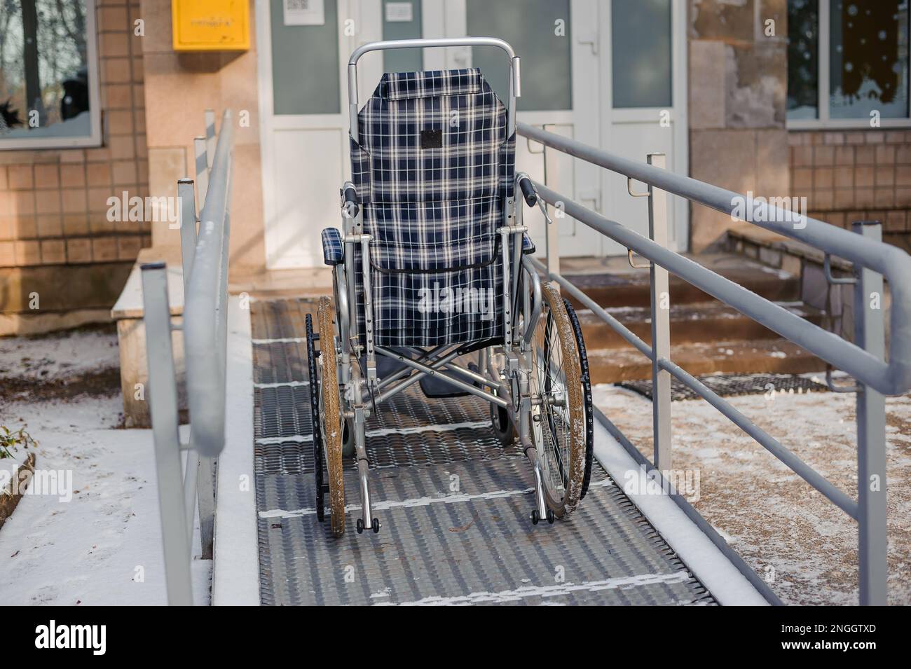 Empty wheelchair in the hospital on the ramp. Wheelchair close-up ...