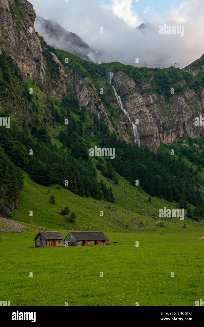 two farmhouses between mountains in the background a waterfall Stock ...