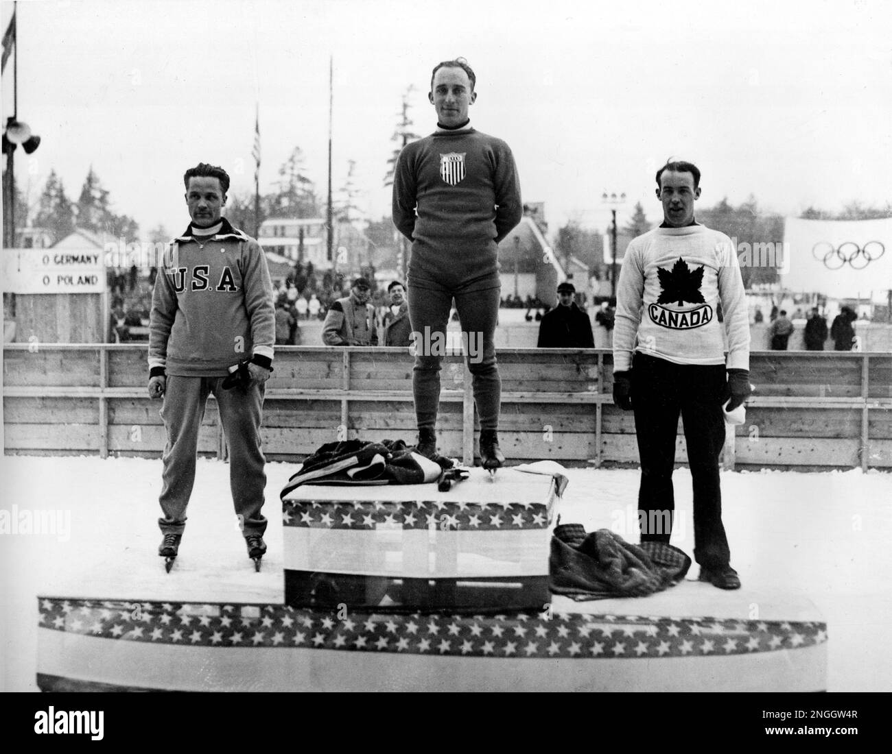 Winners of the 5,000-meter speed skating event stand on the podium at ...