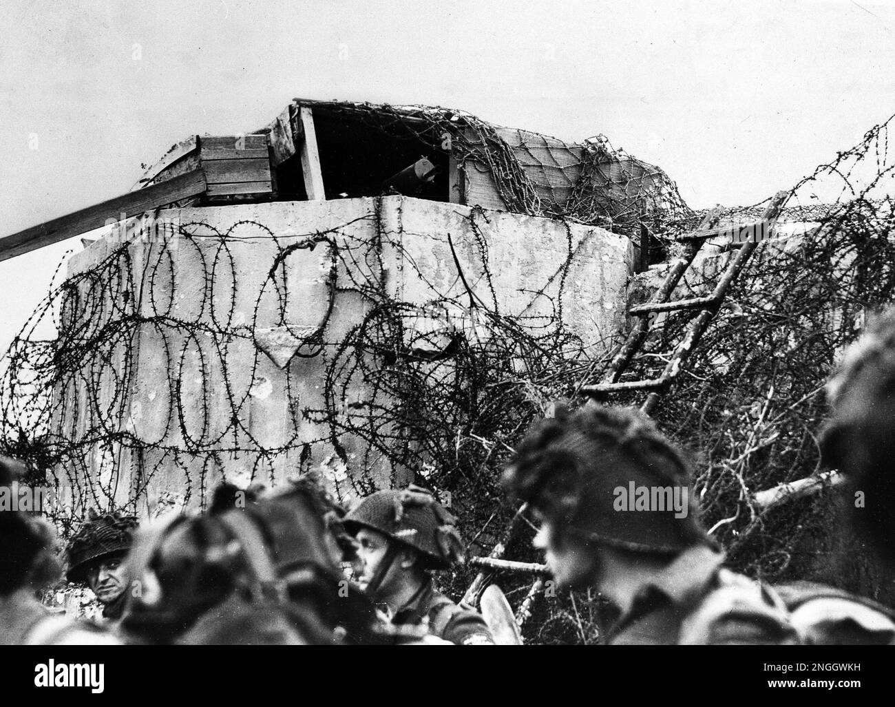 A German machine gun nest along the Atlantic Wall, background, is ...