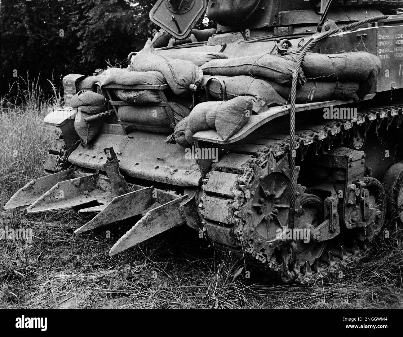 Bulldozer blades are affixed to the front of a tank to be used to ...
