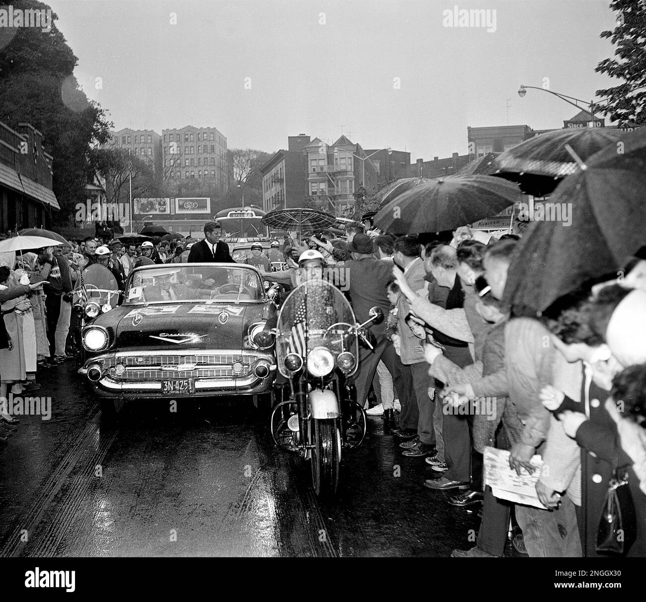 U.S. Sen. John F. Kennedy greets a crowd of people as he arrives in his ...
