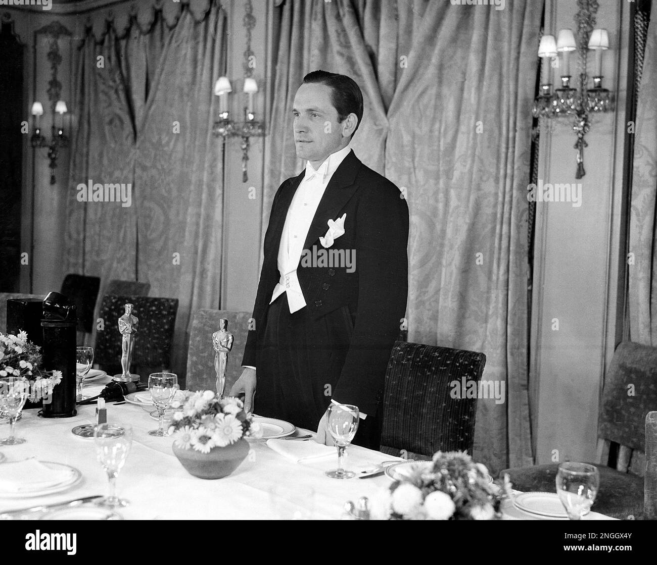 Fredric March acknowledges the applause during dinner of the 1931-32 Motion Picture Academy ...