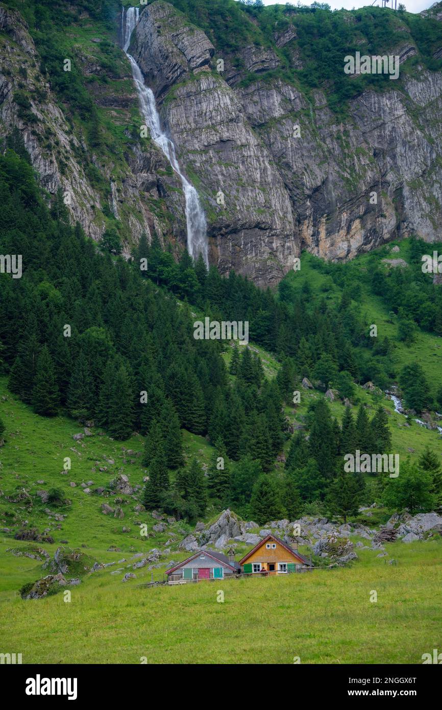 two farmhouses between mountains in the background a waterfall Stock ...