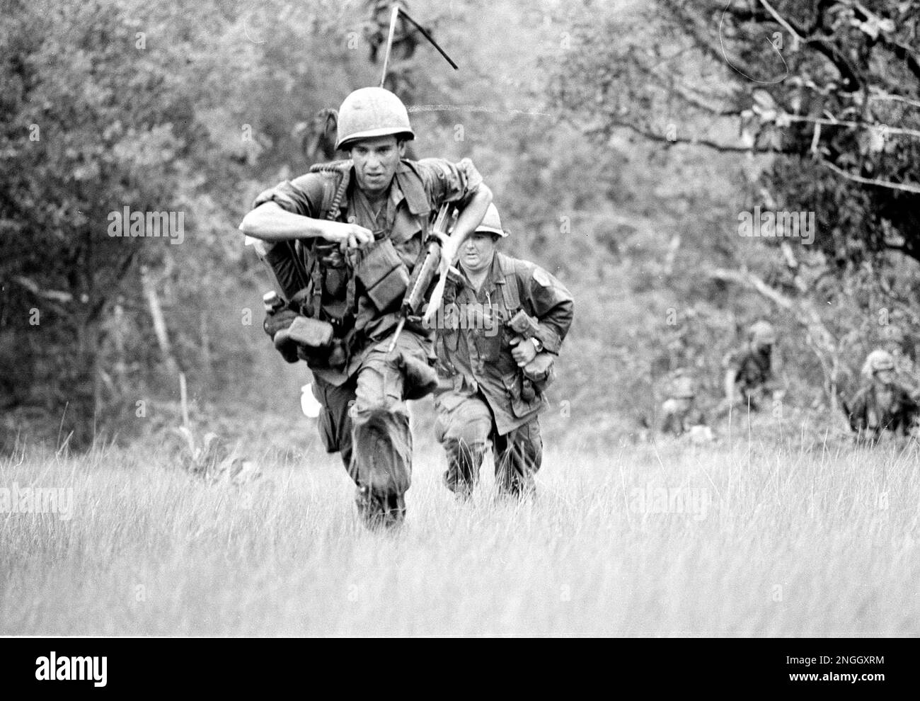 Two infantrymen sprint across the clearing in War Zone D where a U.S ...