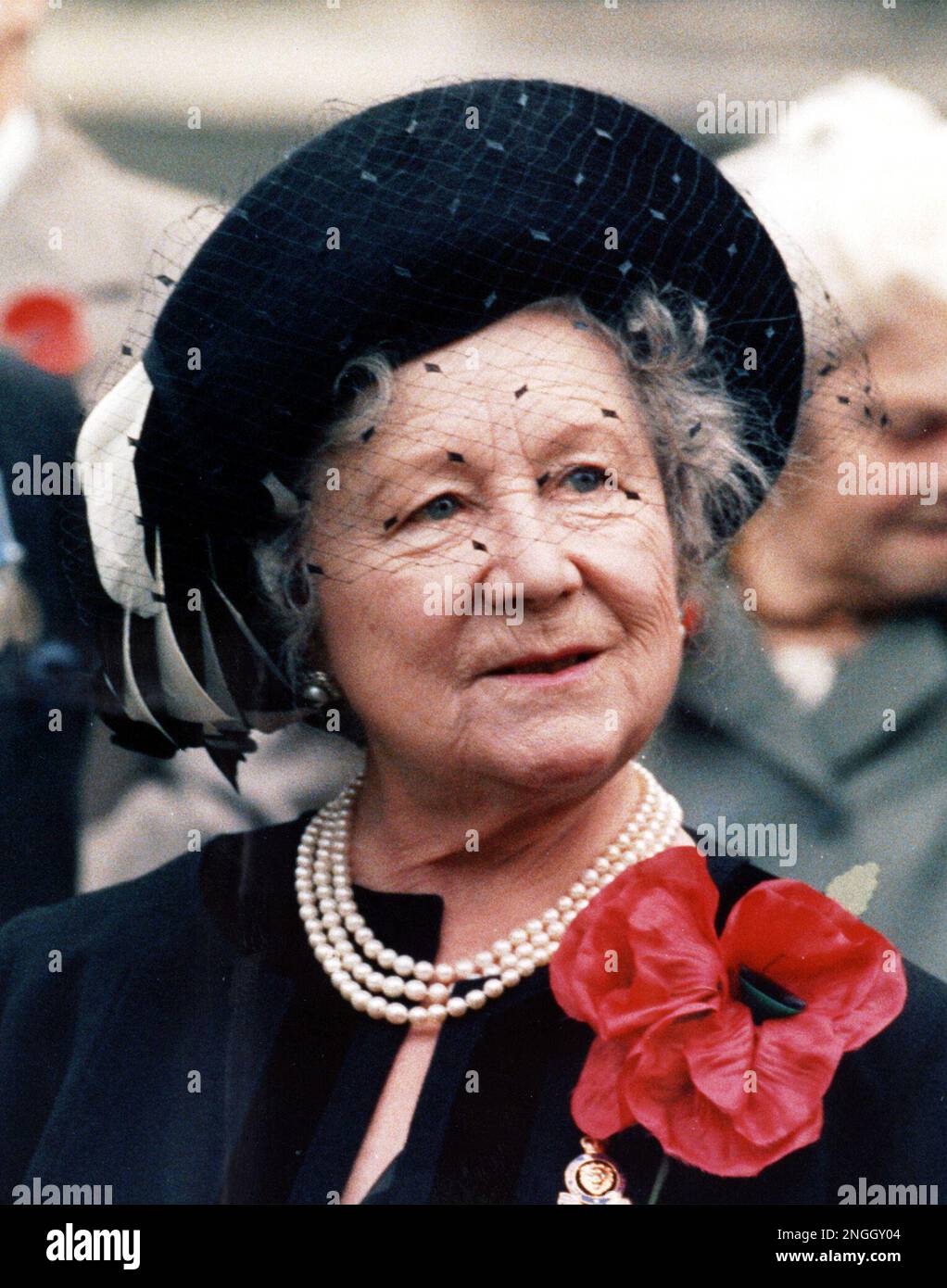 Britain's Queen Elizabeth wears a giant poppy while attending the ...