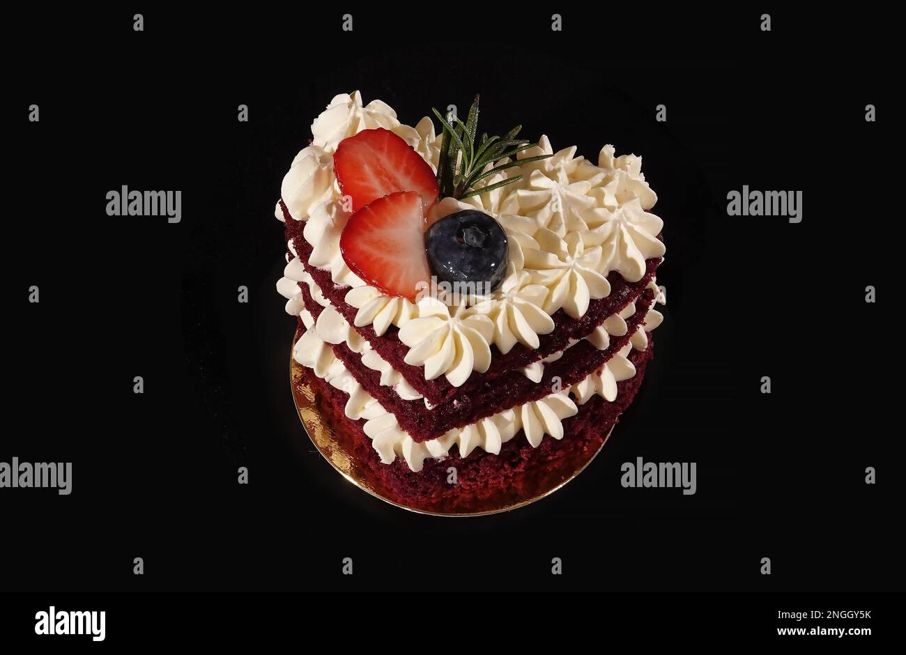 Berry heart cake with cream on a black background - sweets for children ...