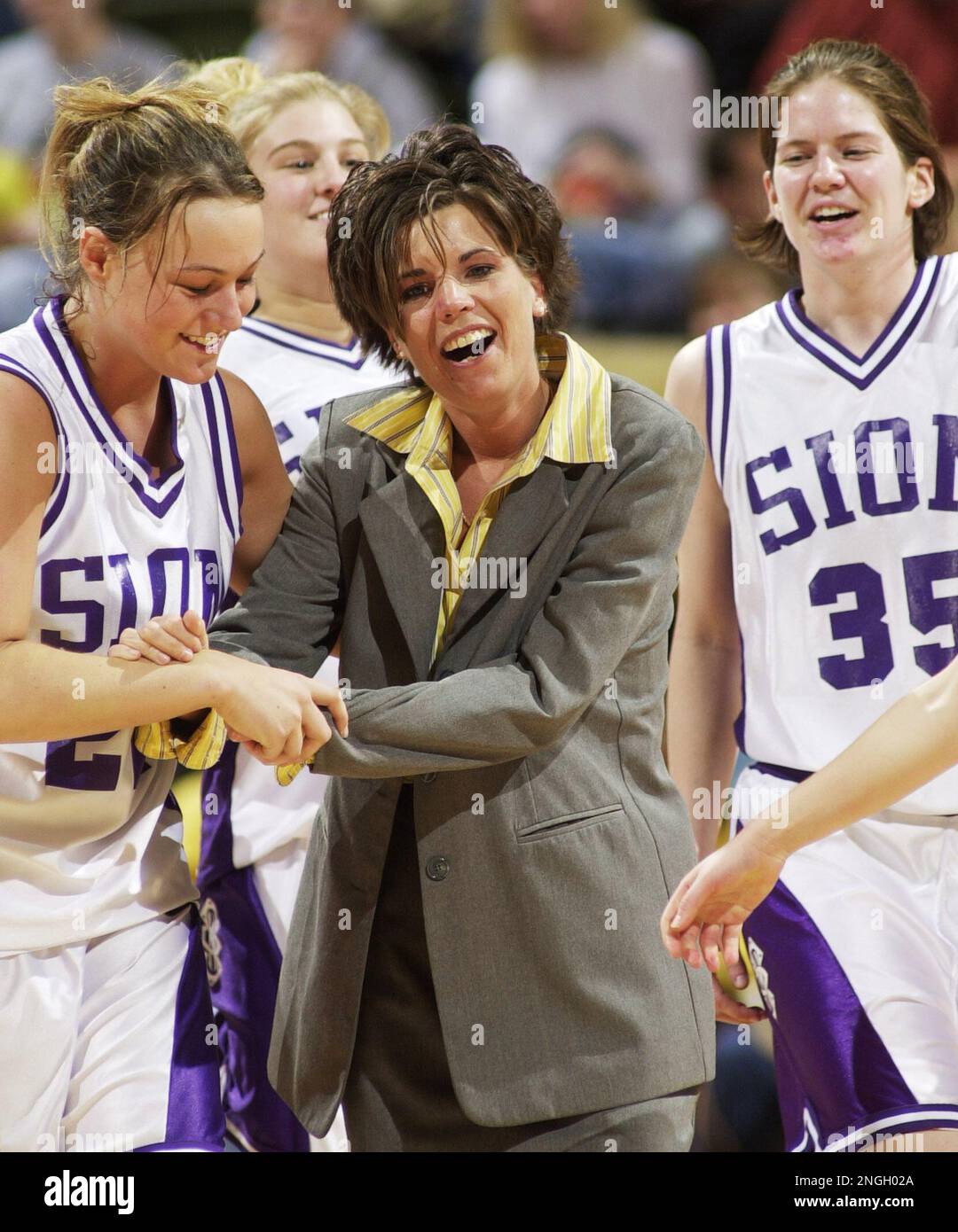Notre Dame de Sion coach Kristy Guffey, center, is congratulated by her ...