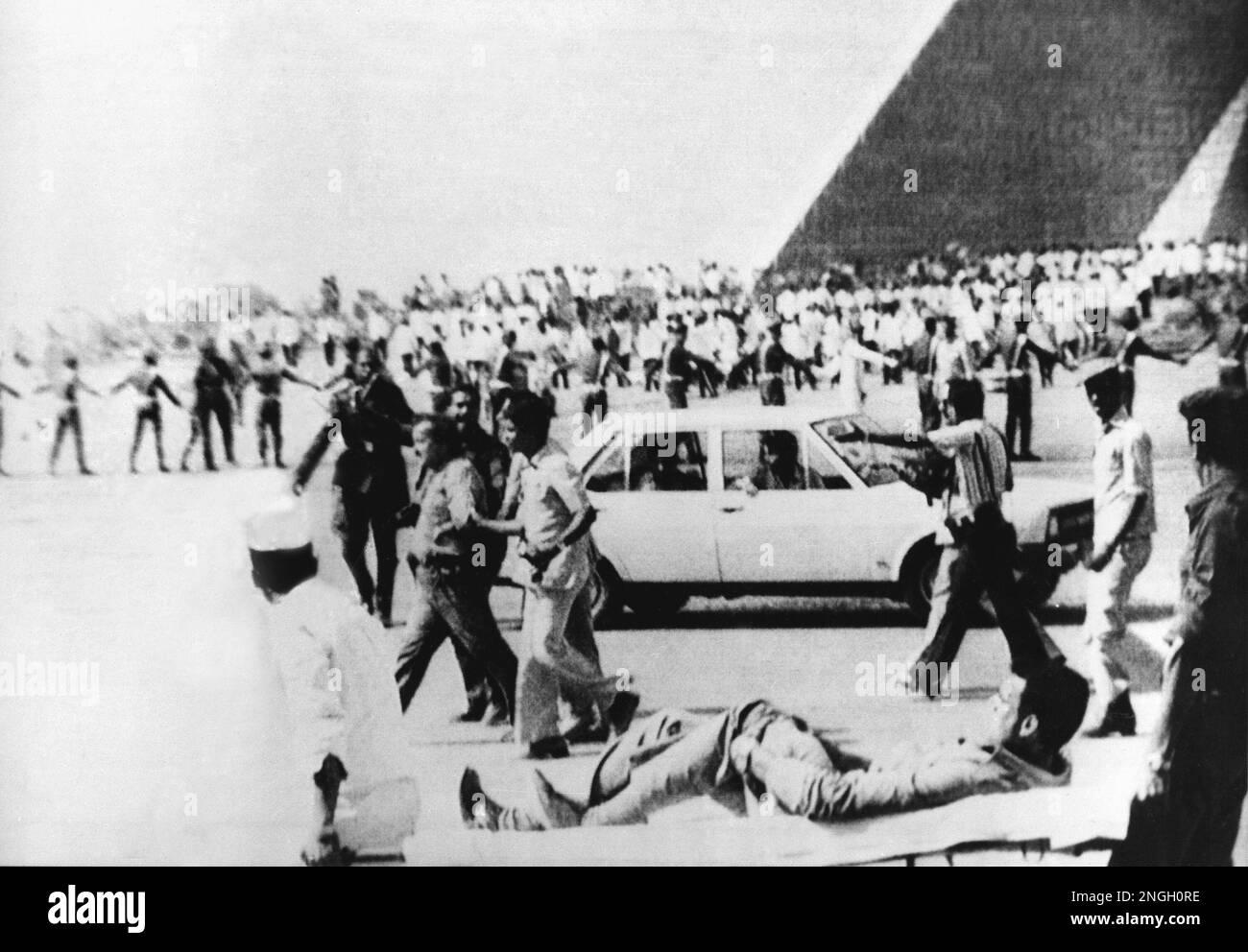 A wounded Egyptian soldier, foreground, is carried away on a stretcher ...