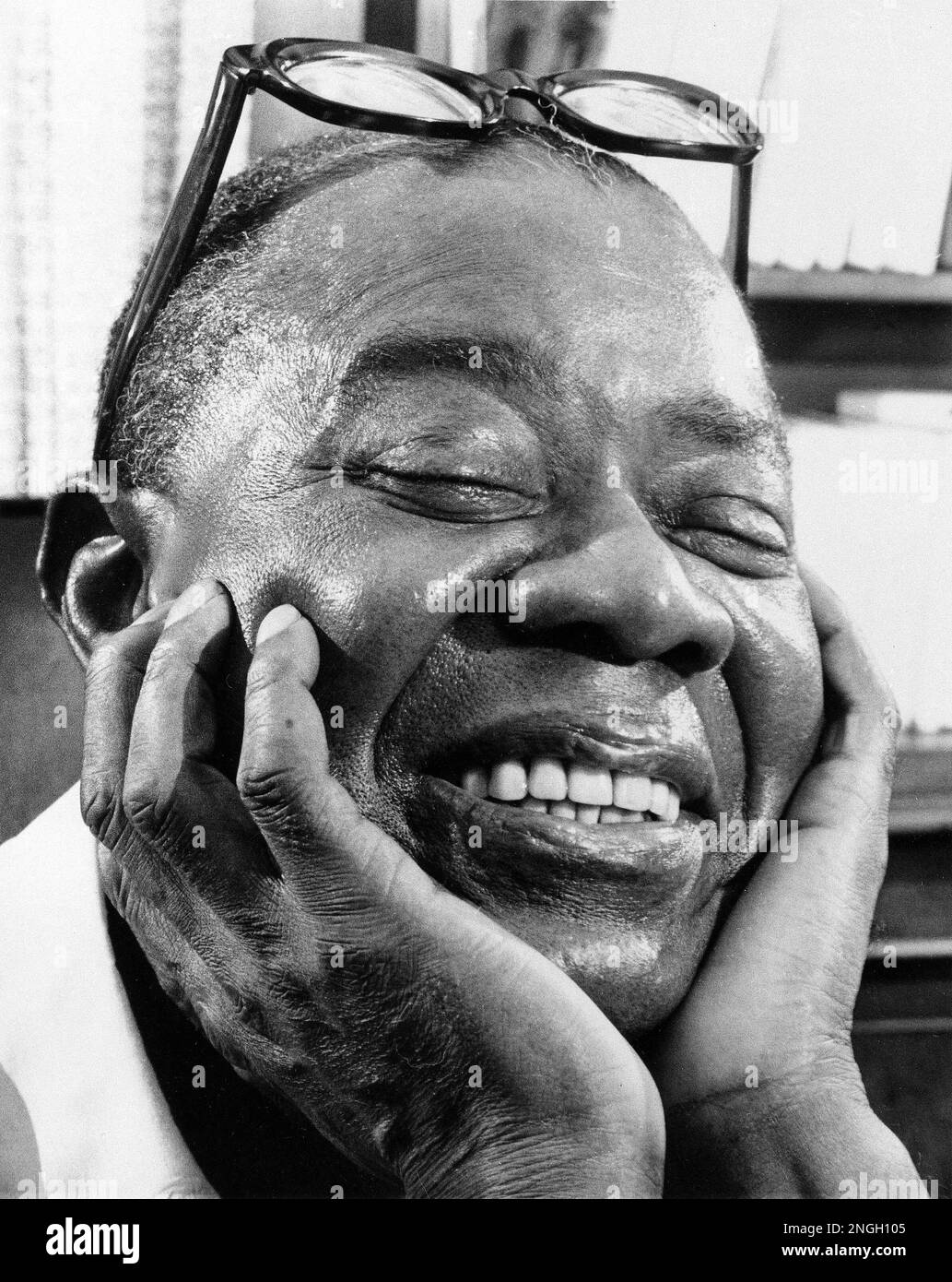 Jazz musician Louis Armstrong smiles as he recalls the the old days ...