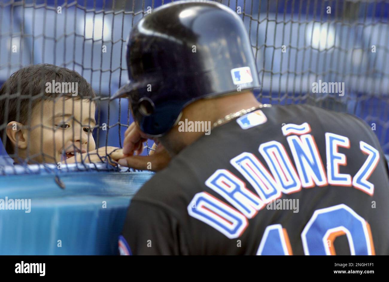 New York Mets shortstop Rey Ordonez holds his son, Anthony Rey's hand ...